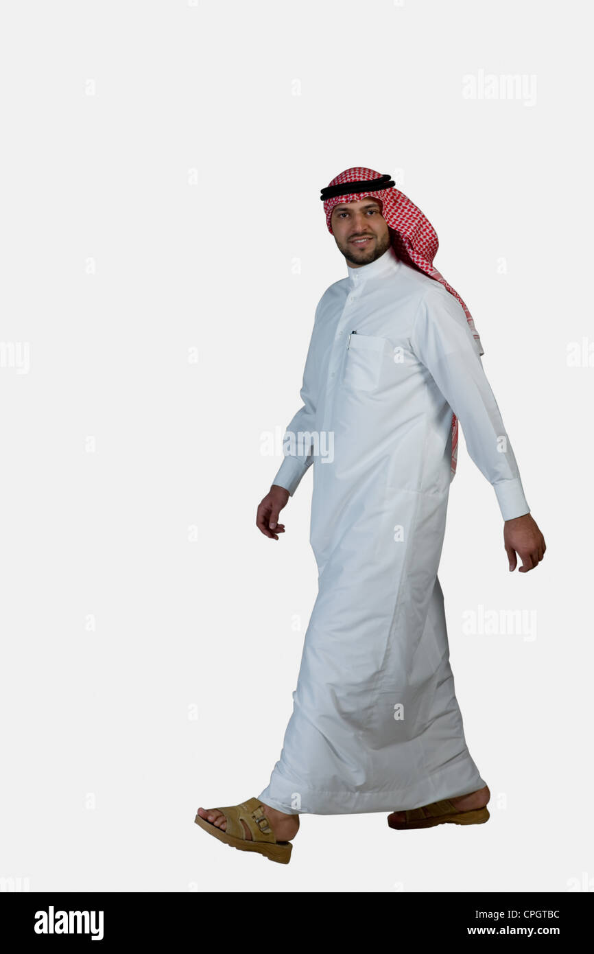 Arab man walking, smiling Stock Photo - Alamy