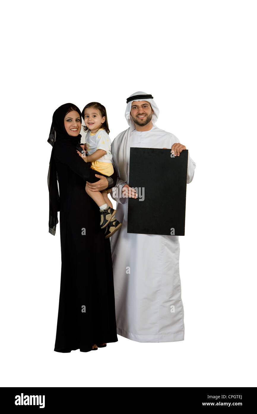 Arab family with placard, smiling, looking at the camera Stock Photo ...