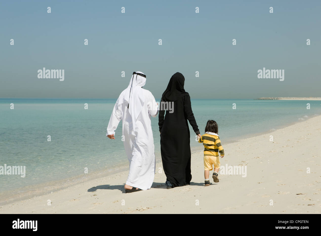 Arab family walking at the beach Stock Photo - Alamy