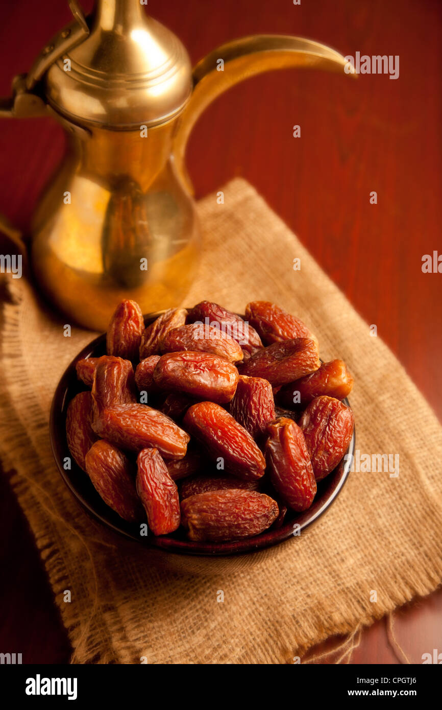 Bowl of dates and teapot on top of a native place mat Stock Photo - Alamy