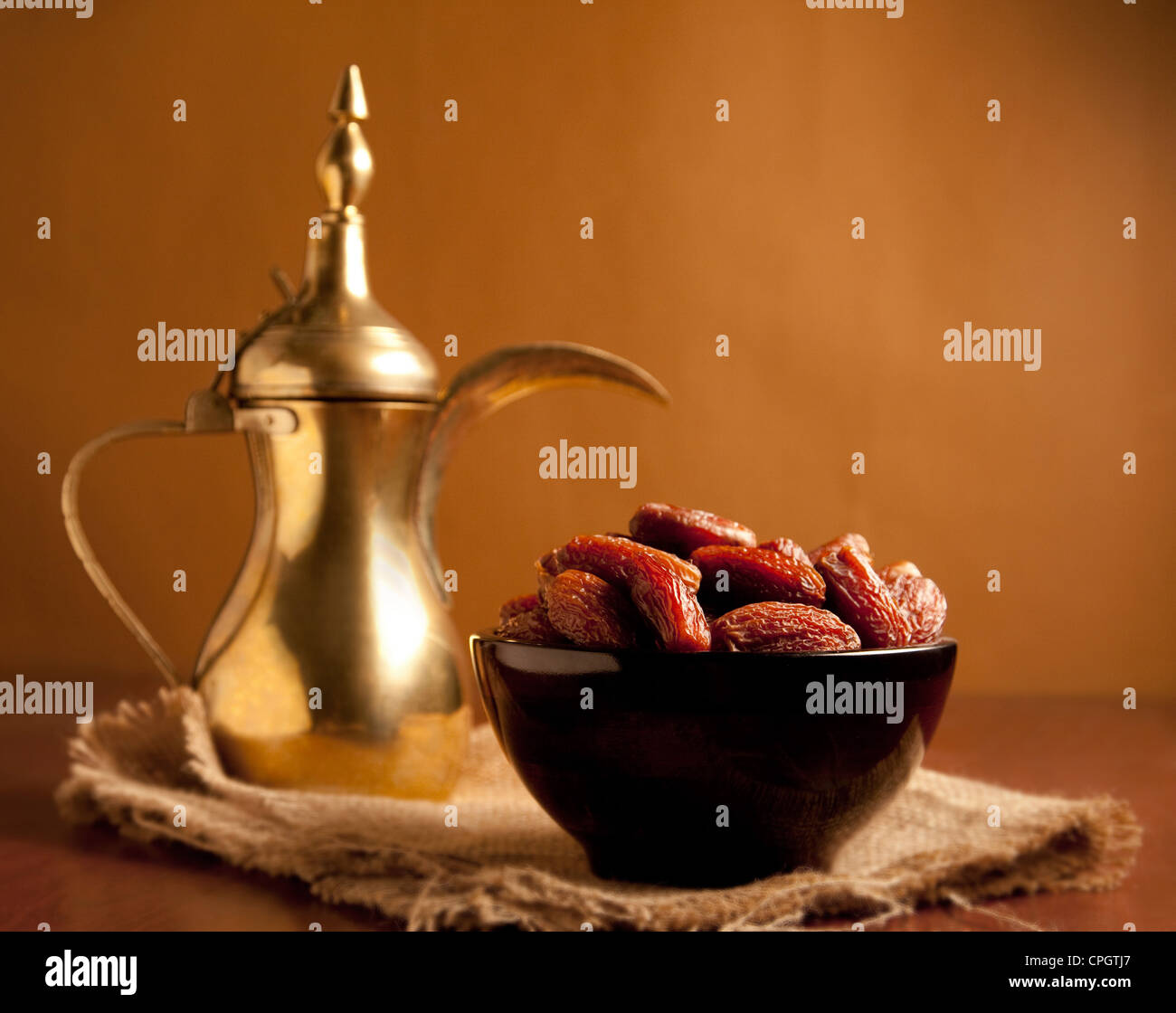 Bowl of dates and teapot on top of a native place mat Stock Photo - Alamy