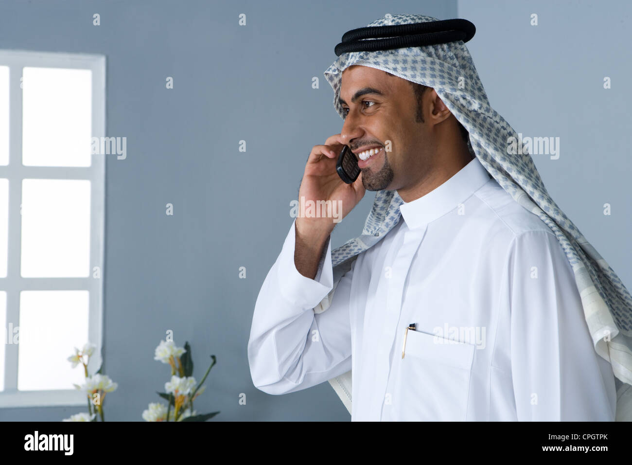 Arab man with cellphone, smiling Stock Photo - Alamy