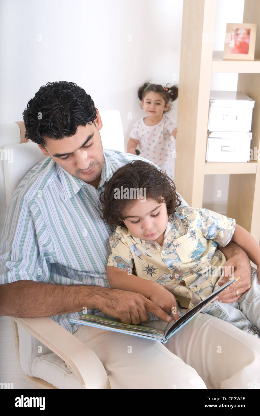 Father and son reading a book together Stock Photo - Alamy