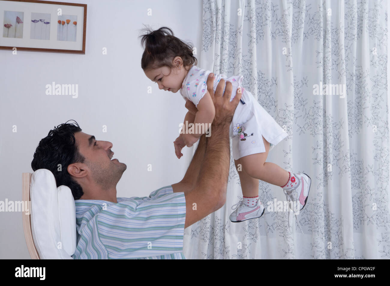 Father lifting her daughter Stock Photo - Alamy