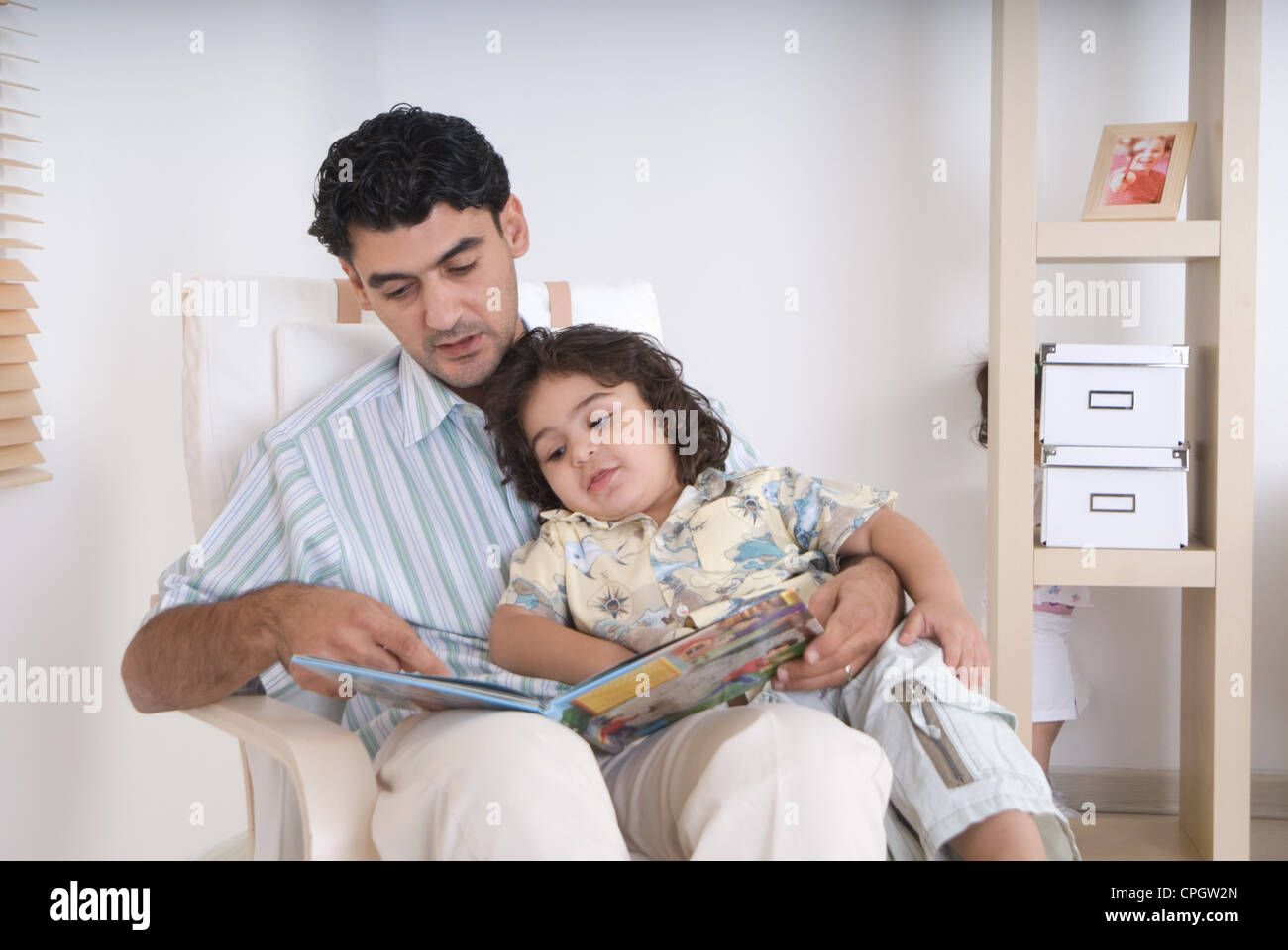 Father and son reading a book together Stock Photo - Alamy