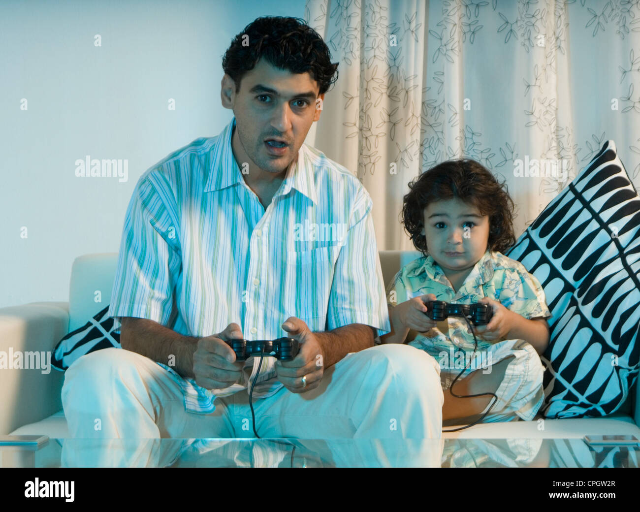Father and son playing video games Stock Photo - Alamy