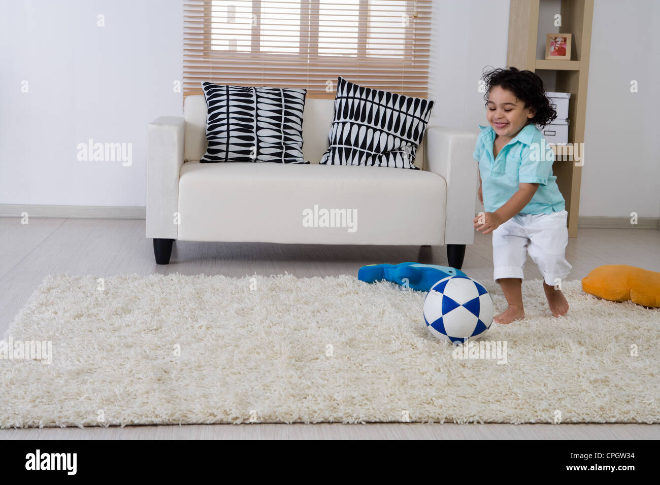 Boy running around the living room Stock Photo - Alamy