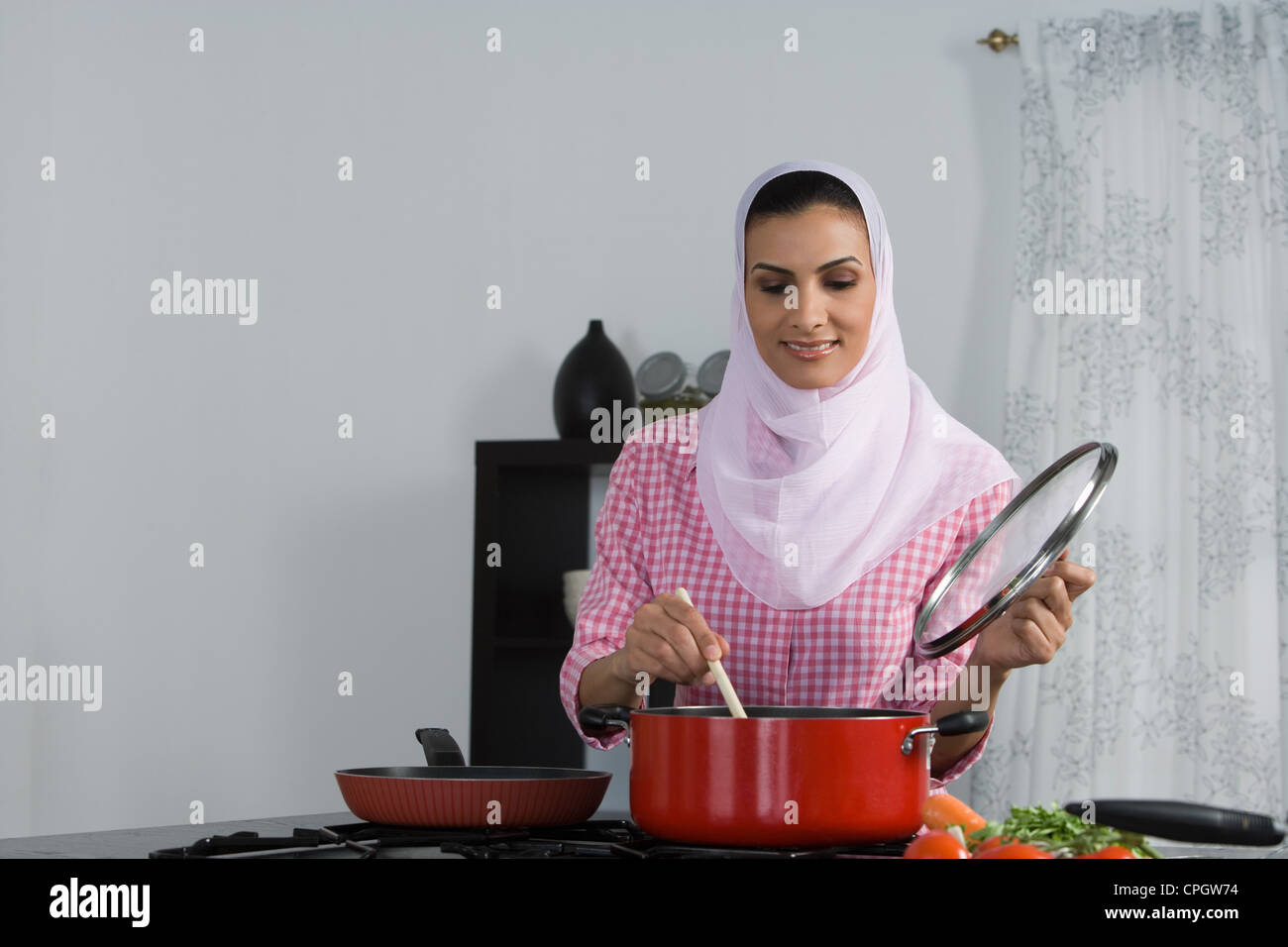 Arab woman cooking in the kitchen Stock Photo - Alamy