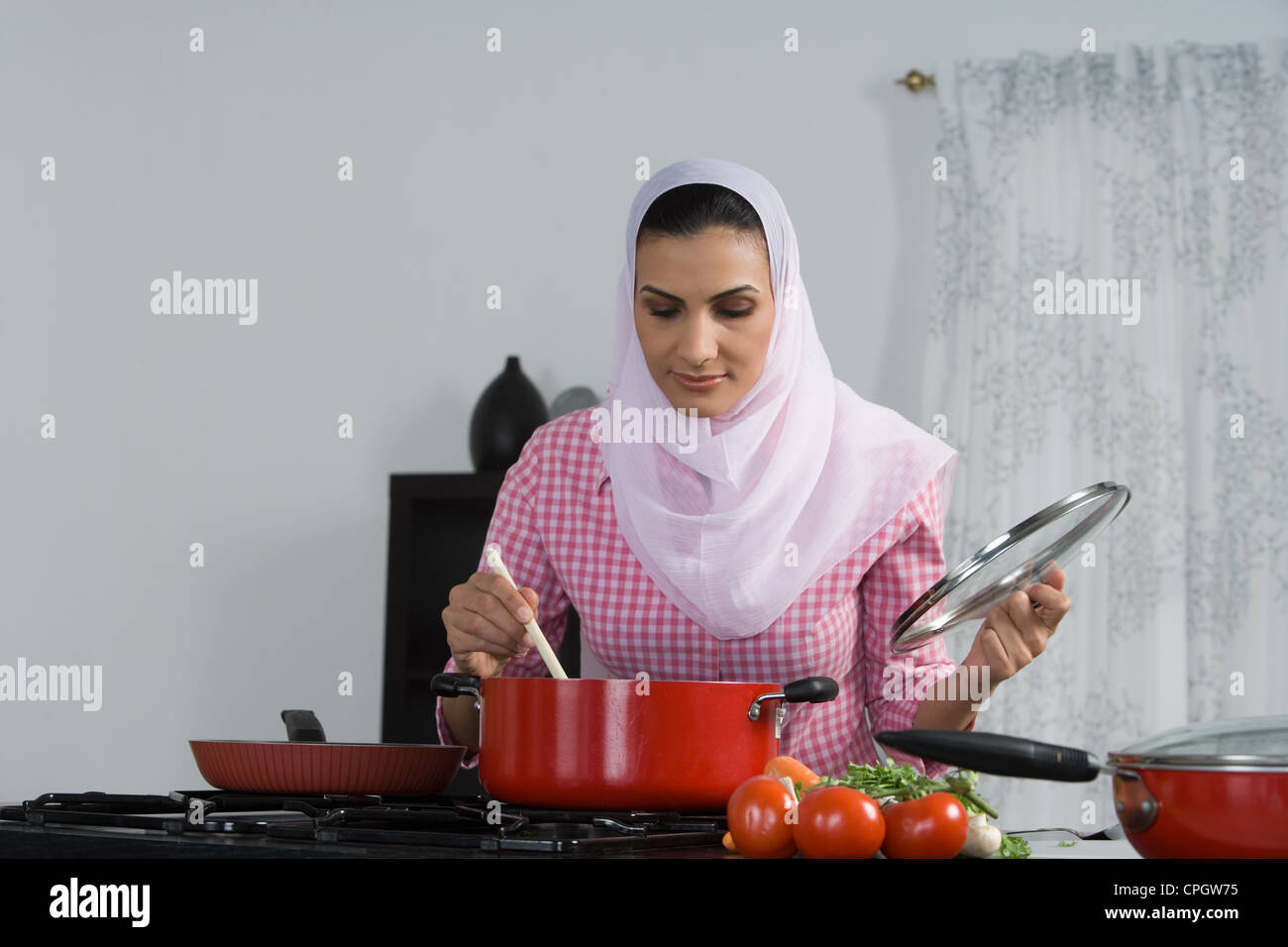 Arab woman cooking in the kitchen Stock Photo - Alamy