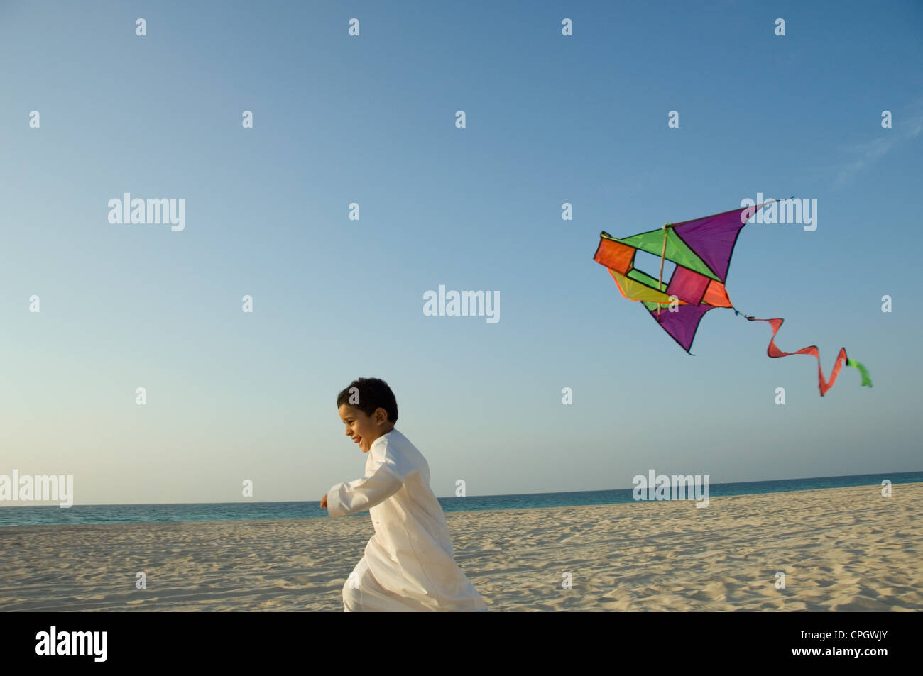 Young boy flying the kite Stock Photo - Alamy