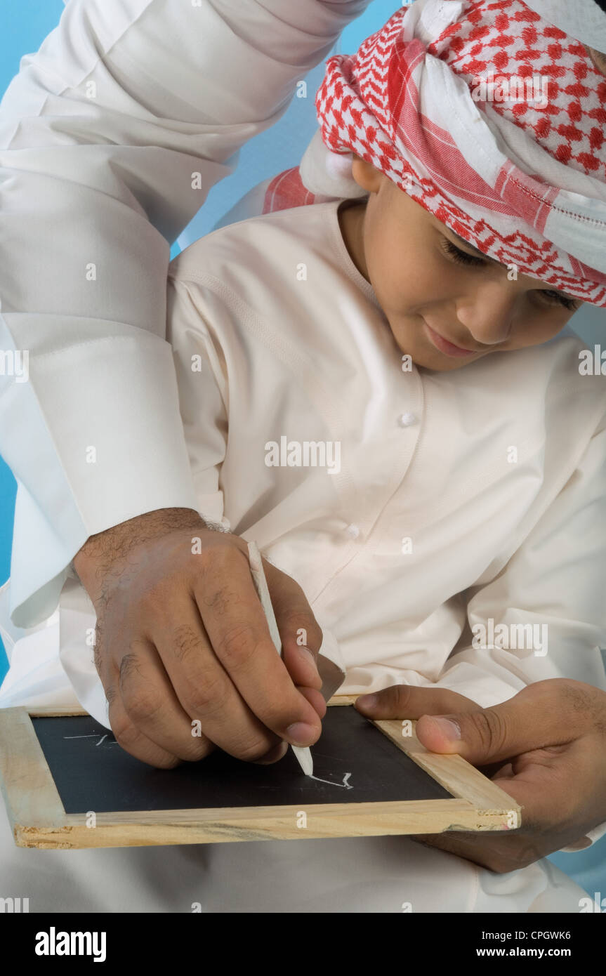 Father teaching young boy to write Stock Photo - Alamy