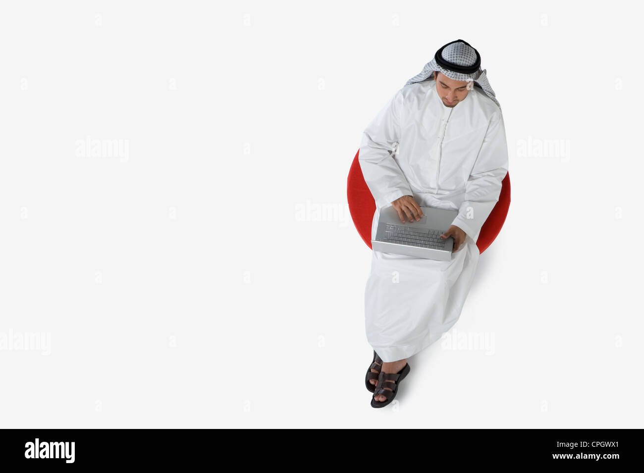 Young man sitting on chair, using laptop, top view Stock Photo - Alamy