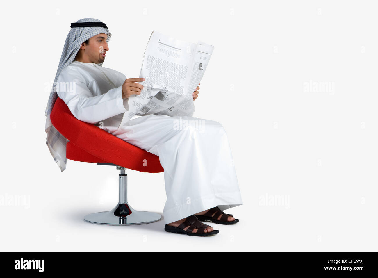 Young man reading newspaper, side view Stock Photo - Alamy
