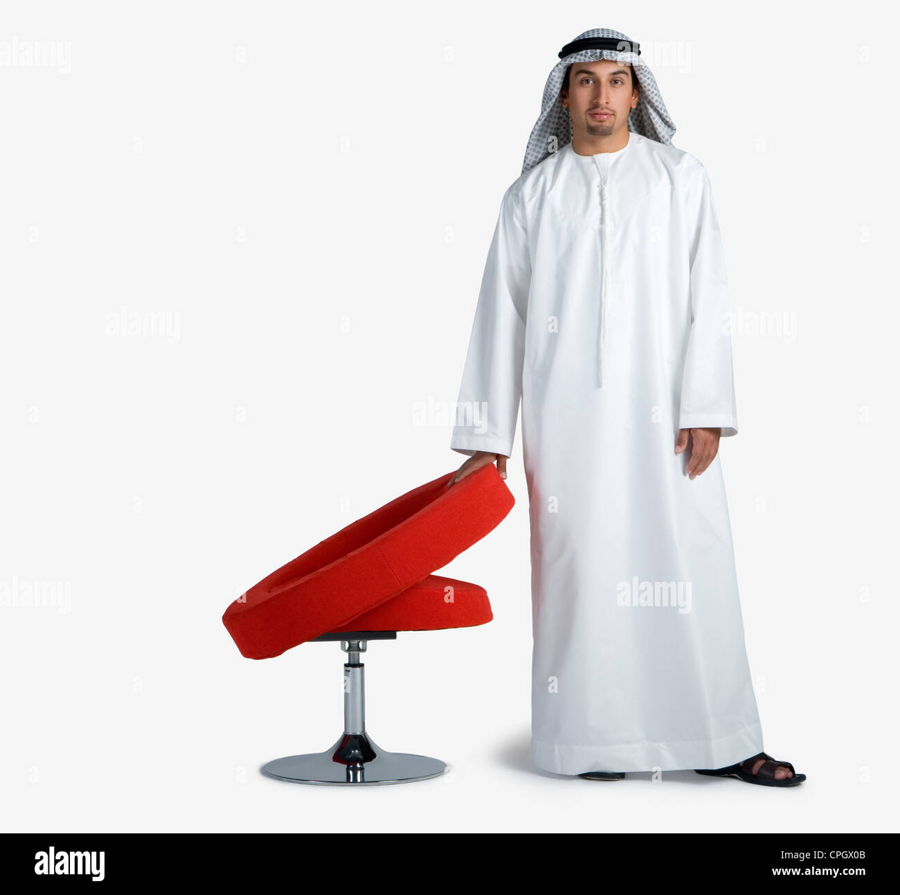 Young man standing near chair, portrait Stock Photo - Alamy