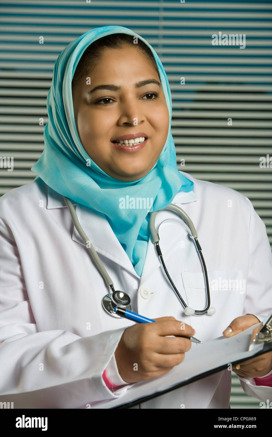 Portrait of a female doctor holding a medical chart Stock Photo - Alamy