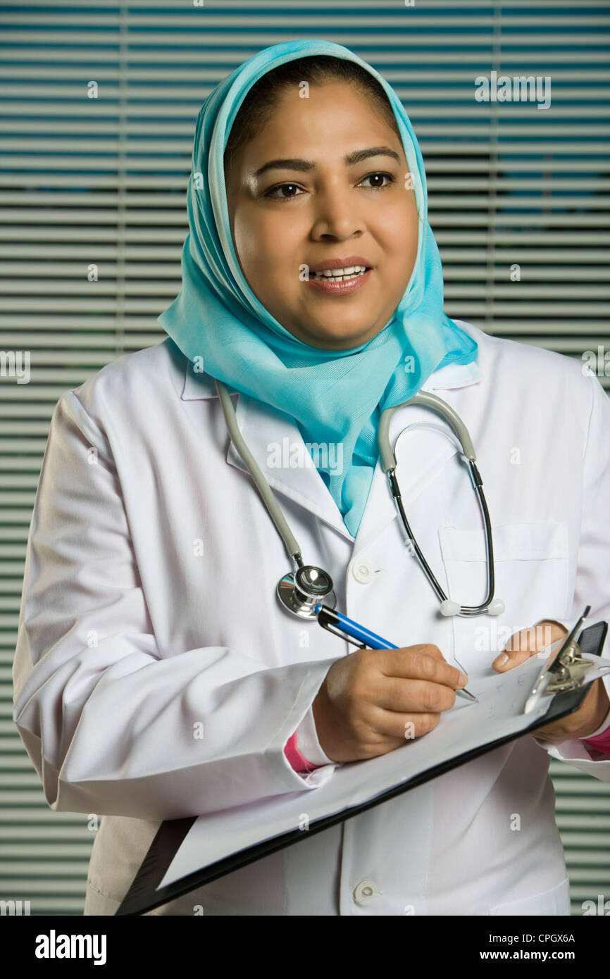 Portrait of a female doctor holding a medical chart Stock Photo - Alamy