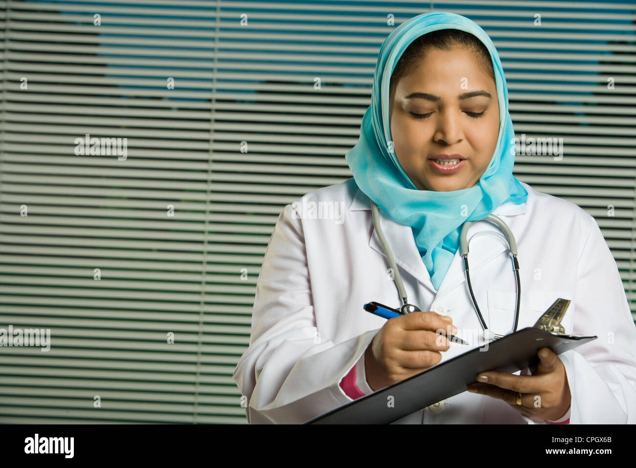 Portrait of a female doctor holding a medical chart Stock Photo - Alamy