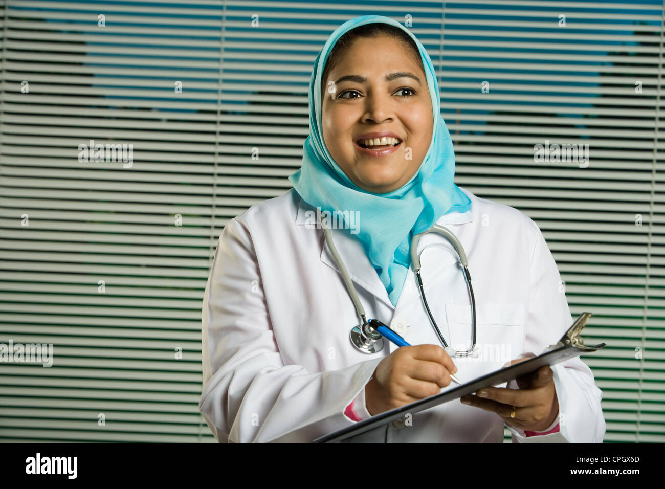 Portrait of a female doctor holding a medical chart Stock Photo - Alamy