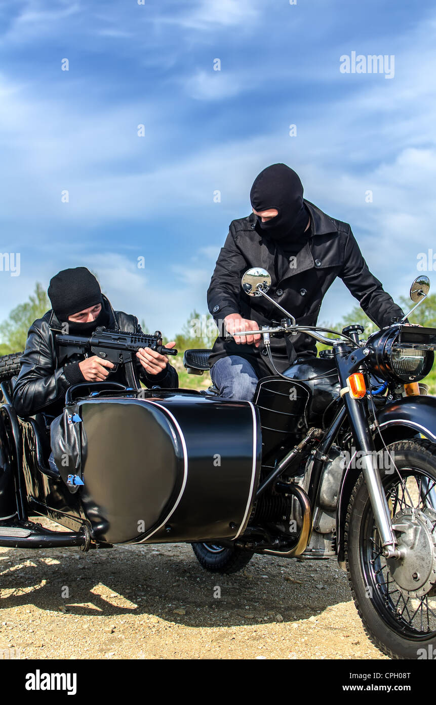 Two armed men riding a motorcycle with a sidecar Stock Photo - Alamy