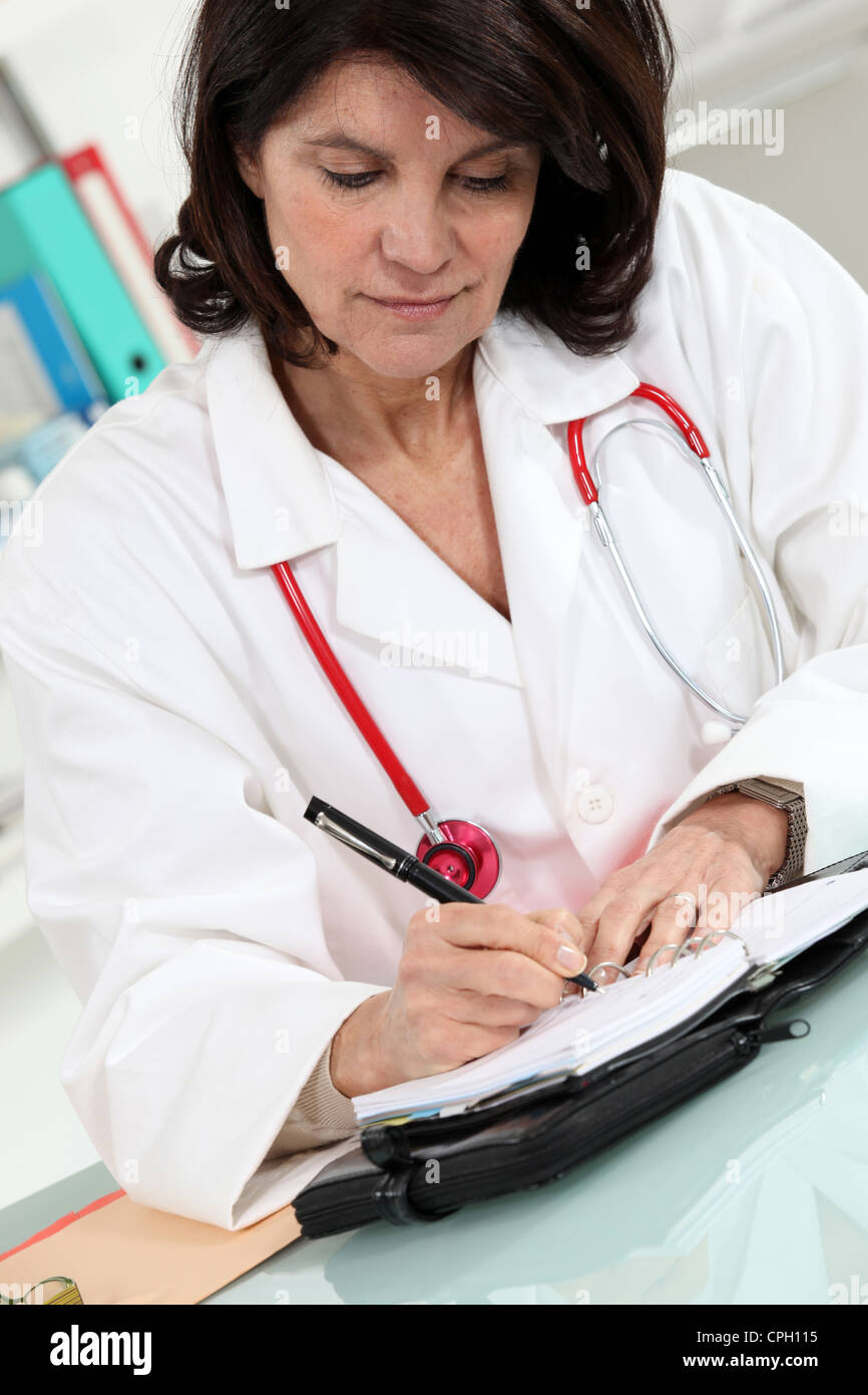 Doctor writing a prescription Stock Photo - Alamy