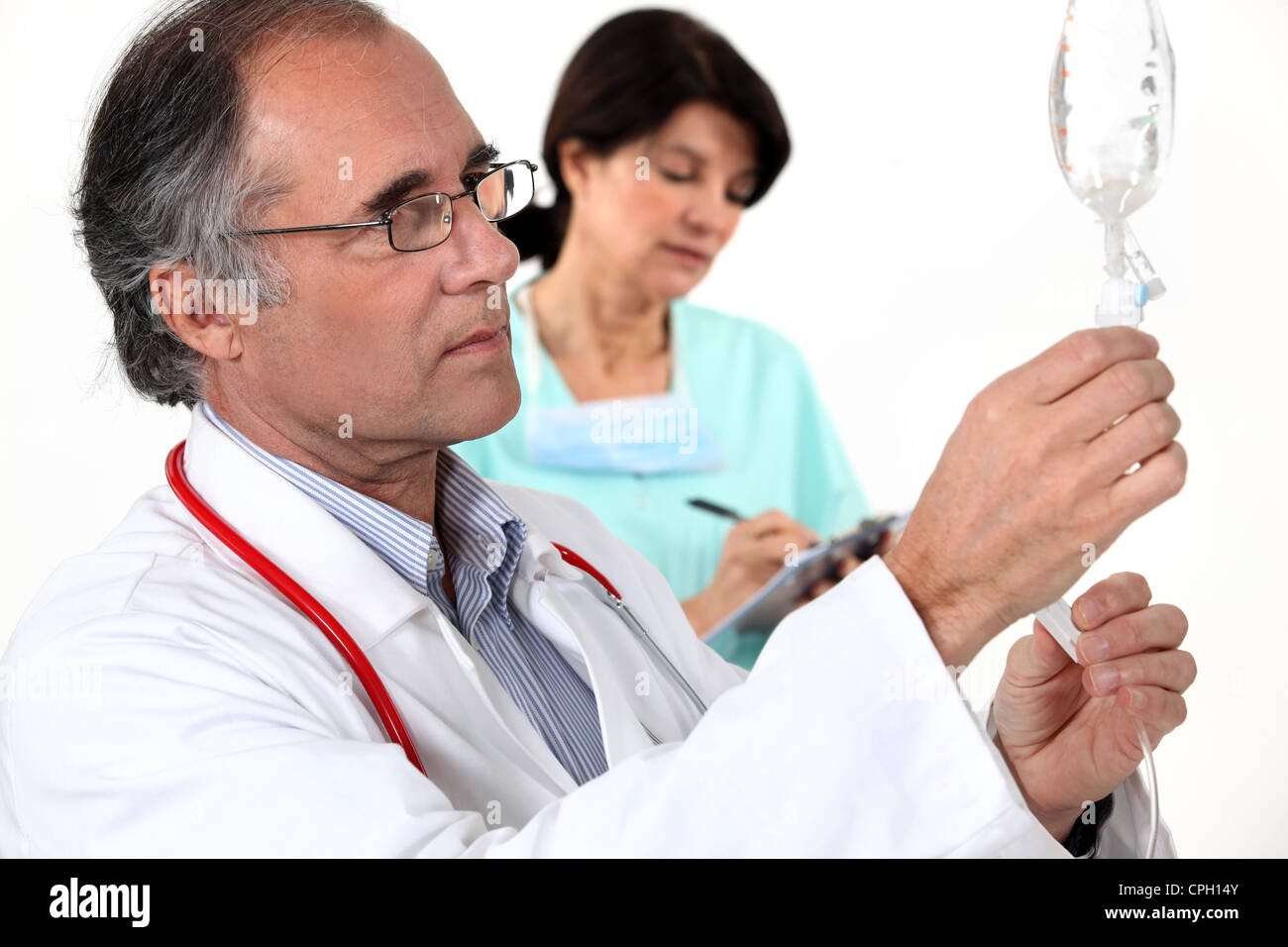 Doctor and nurse preparing IV drip Stock Photo - Alamy