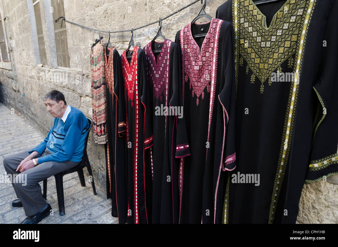 Palestinian hawker selling traditional palestinian dresses in the ...