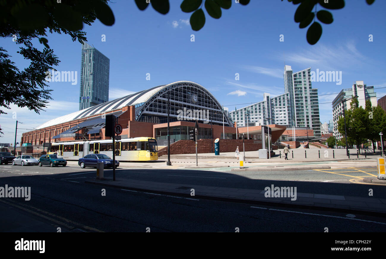 Manchester Central basking in sun as a yellow Metrolink tram passes ...