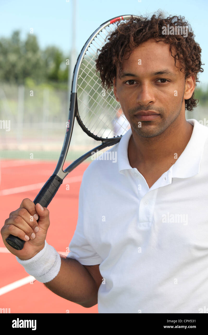 Tennis player holding racket Stock Photo - Alamy