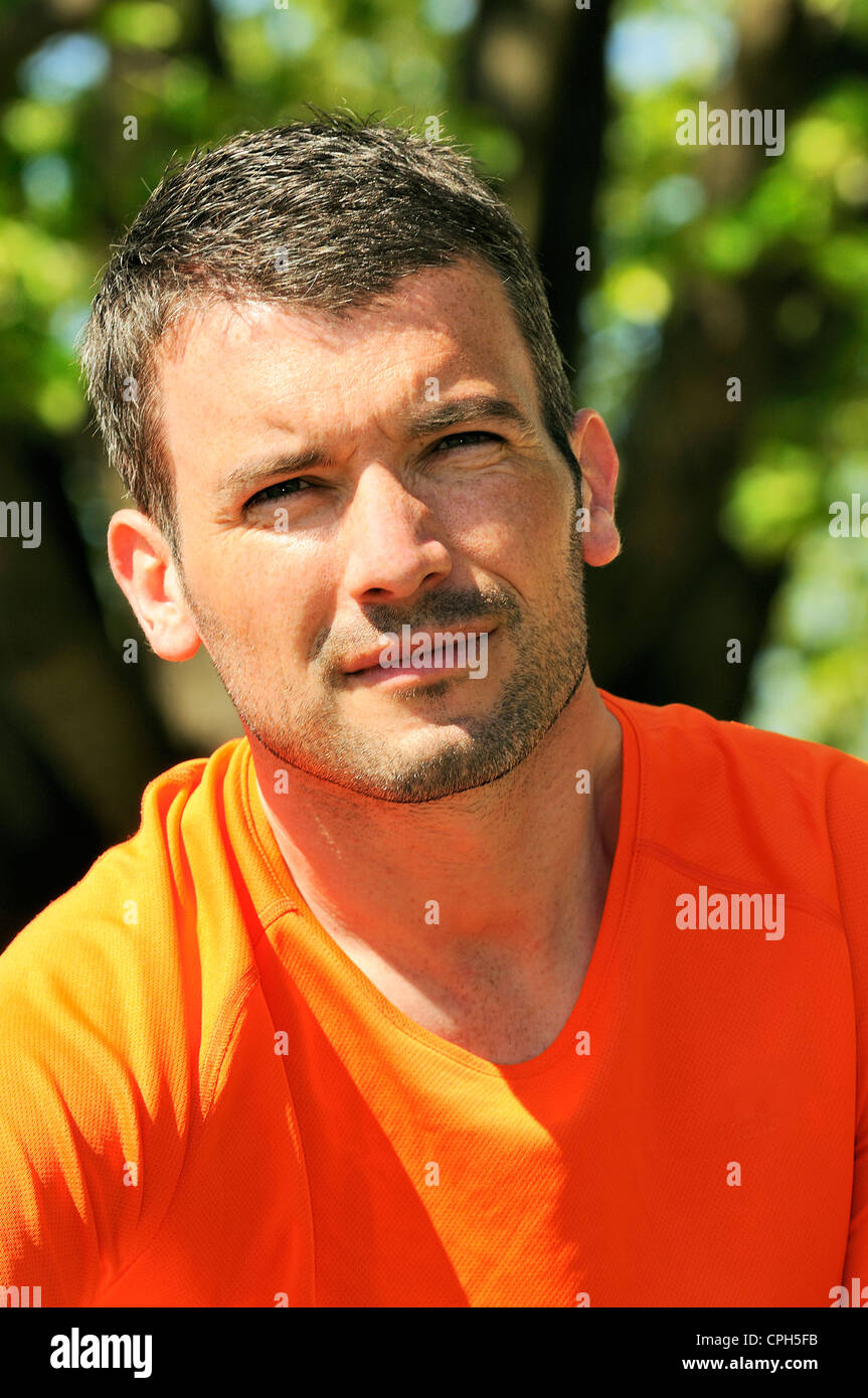natural looking young man with orange clothed Stock Photo - Alamy