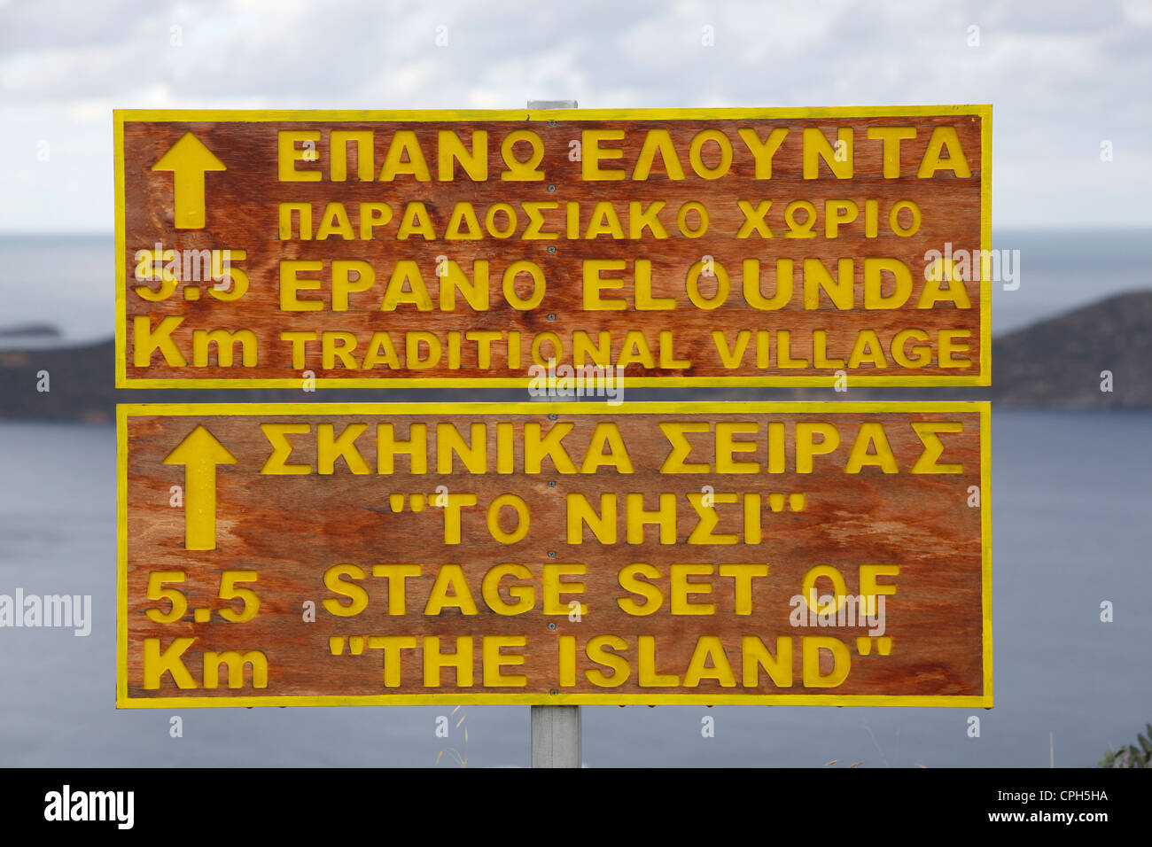 A Road sign in English and Greek language in the bay of Elounda at the ...