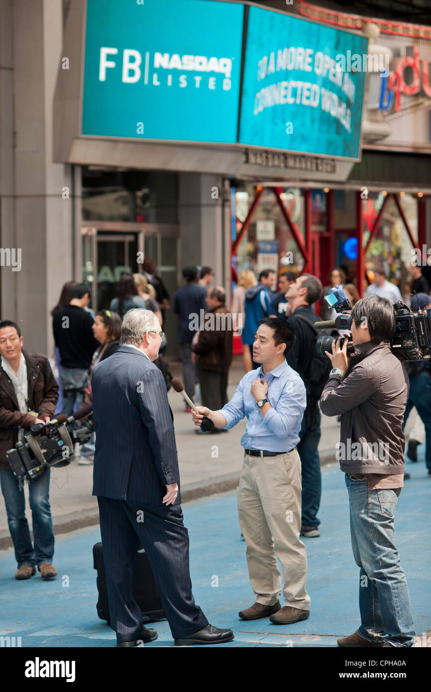 Media interview passer-by outside of NASDAQ headquarters in Times ...