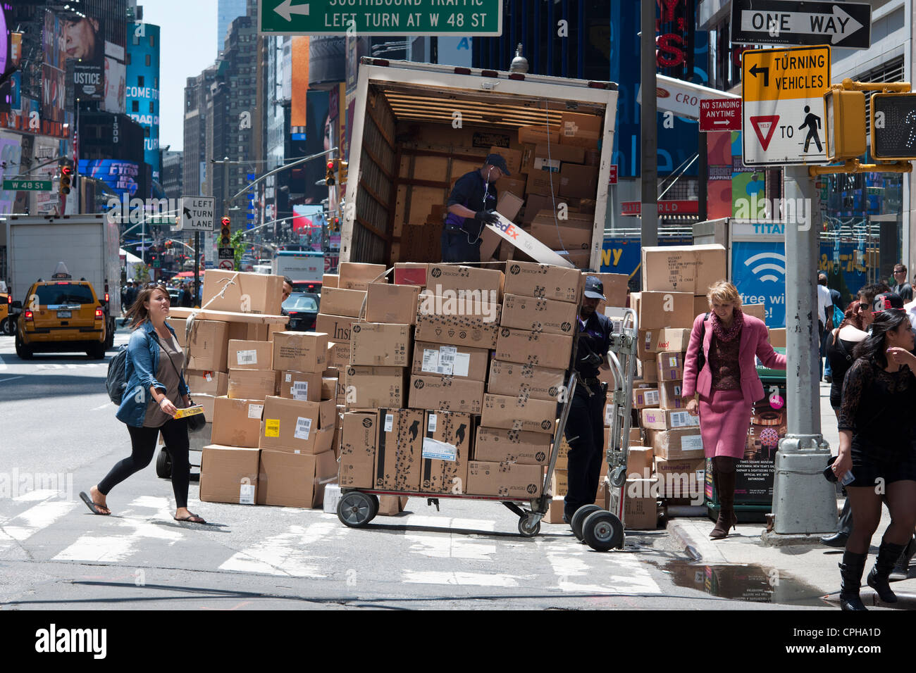 Employees of FedEx sort packages for delivery in Midtown Manhattan in ...