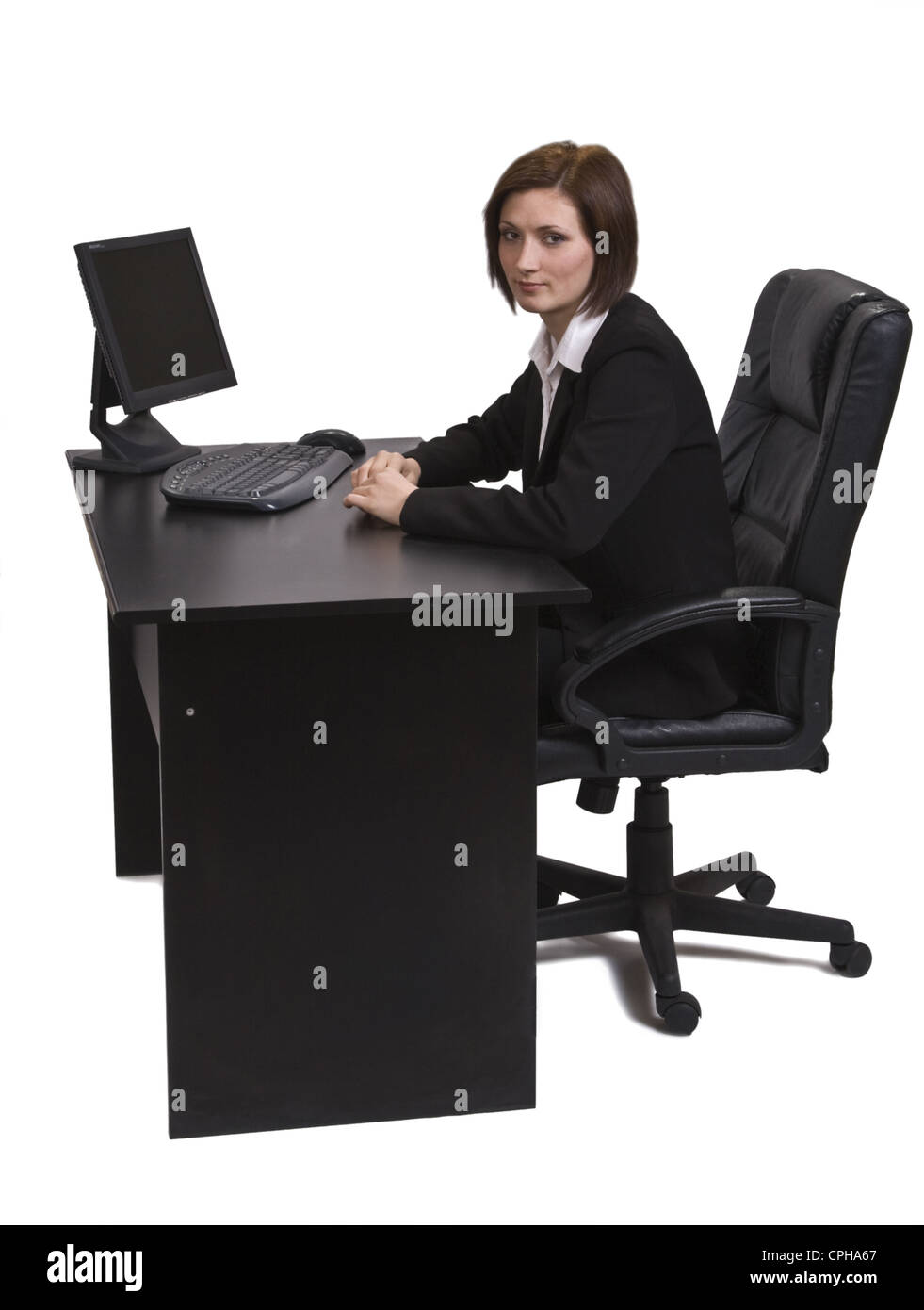 Businesswoman siting in front of a computer at her desk Stock Photo - Alamy