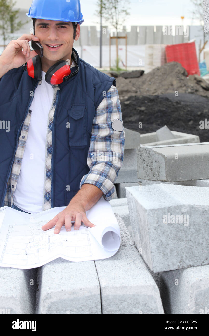 Operator on site with map Stock Photo - Alamy