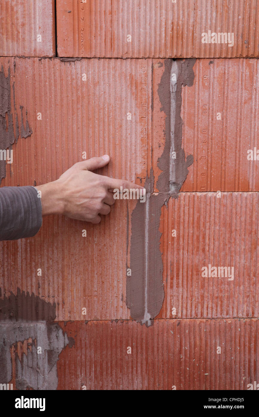 Man pointing out problem with wall Stock Photo - Alamy