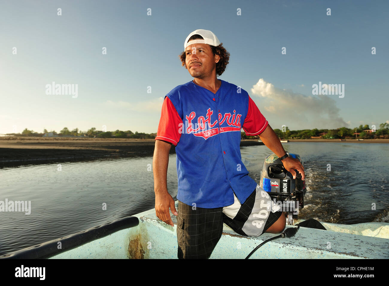 Man, sports jacket, baseball hat, captain, riding, boat, mangrove ...