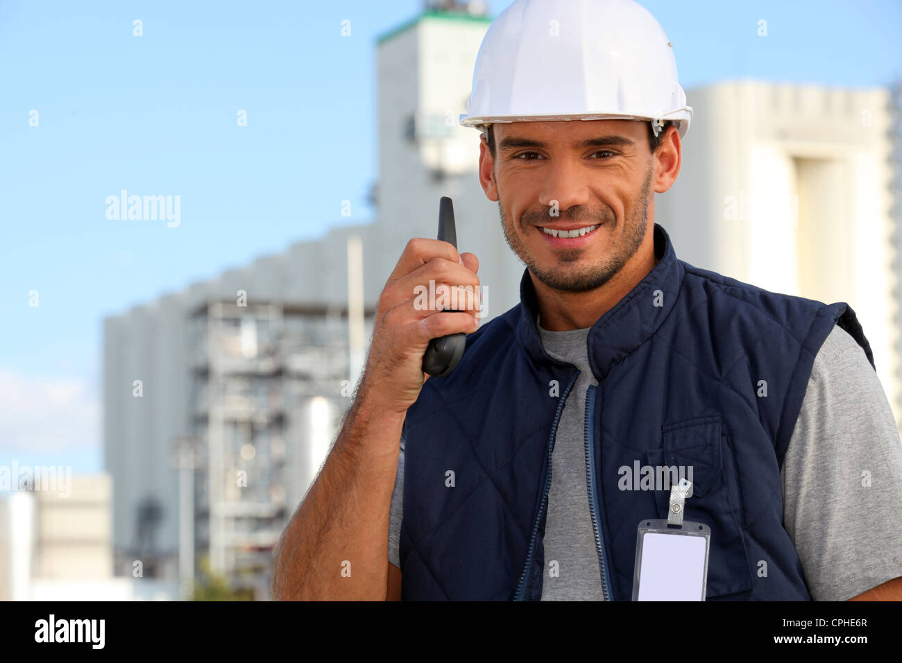 Construction worker speaking into his walkie-talkie Stock Photo - Alamy