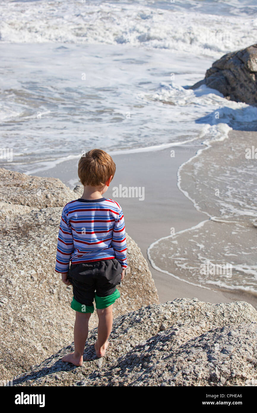 Boy standing sea watching waves hi-res stock photography and images - Alamy