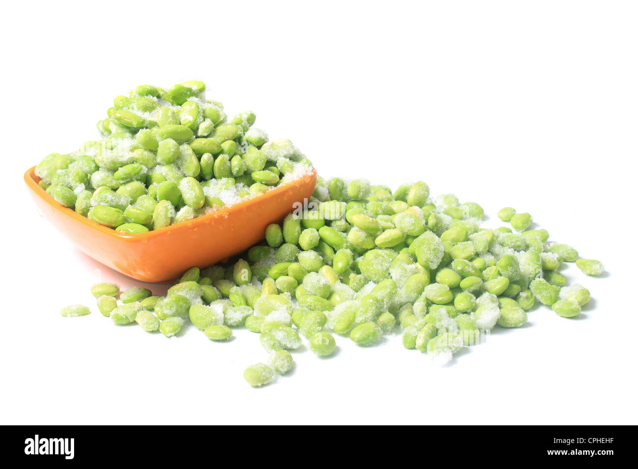 Frozen edamame also known as soybeans in a bowl on a white background ...