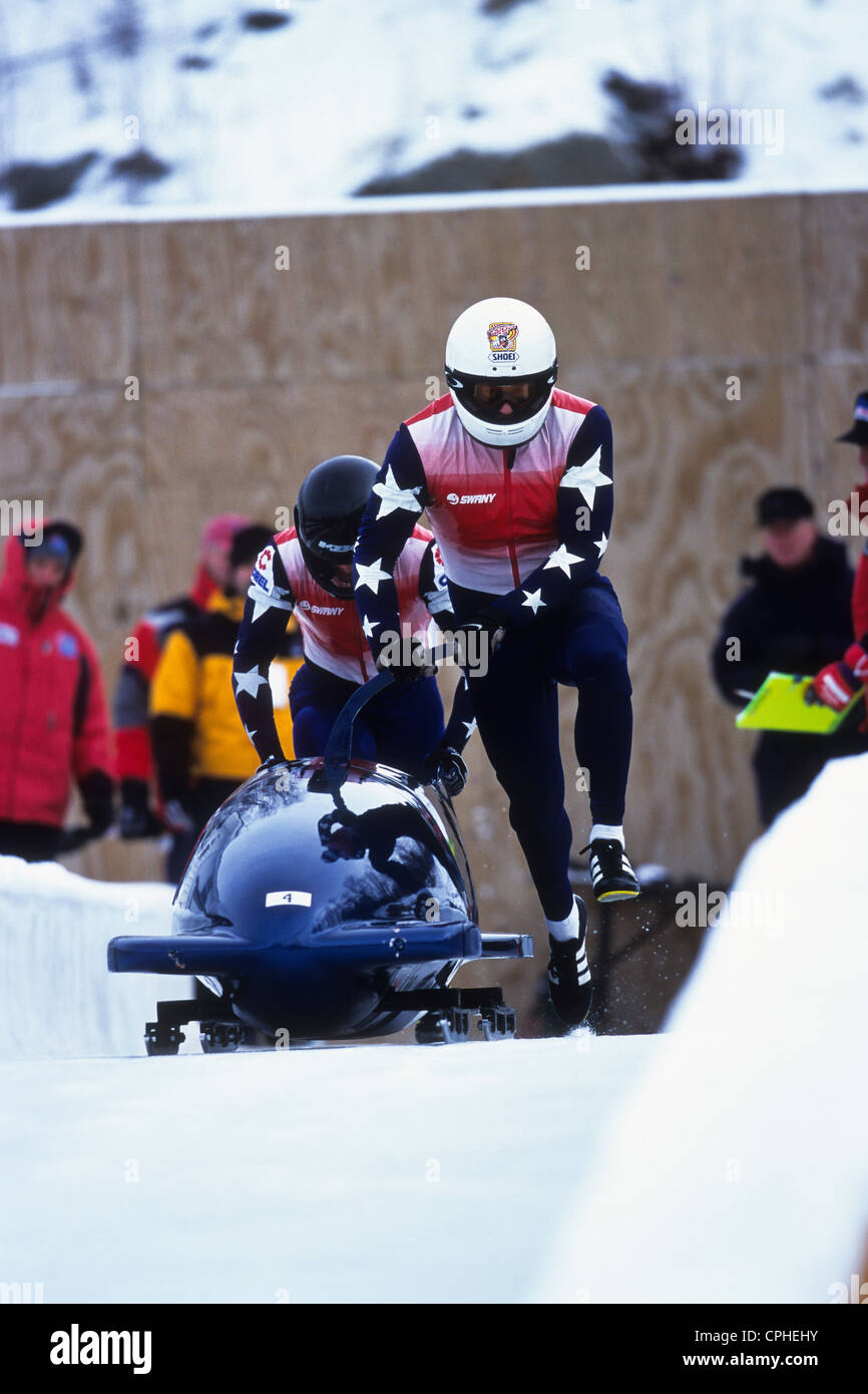Two man bobsled team pushing off at the start Stock Photo - Alamy