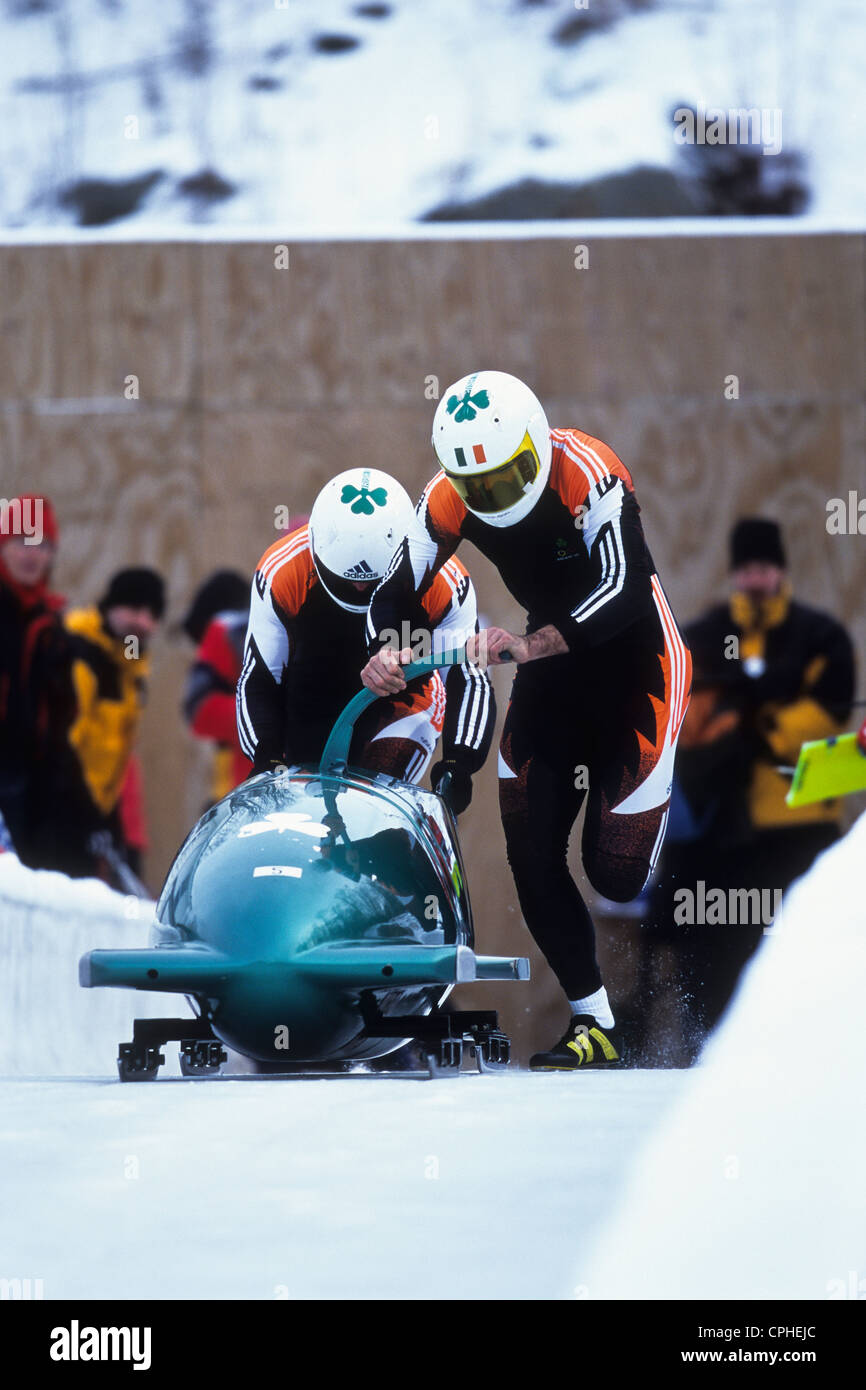 Two man bobsled team pushing off at the start Stock Photo - Alamy