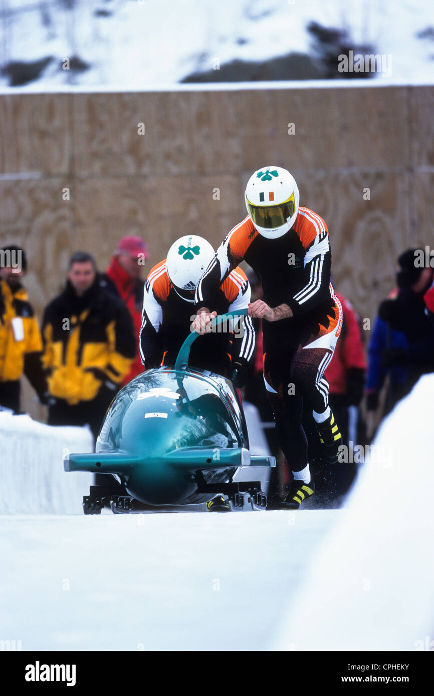 Two man bobsled team pushing off at the start Stock Photo - Alamy