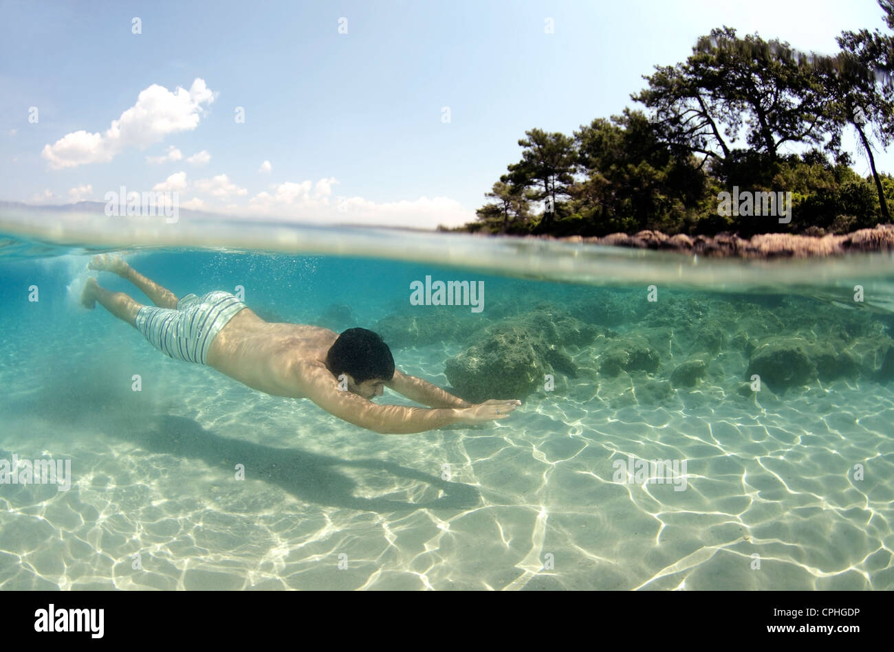 Split level, the man diving, Cleopatra island (Sedir Island), Aegean ...