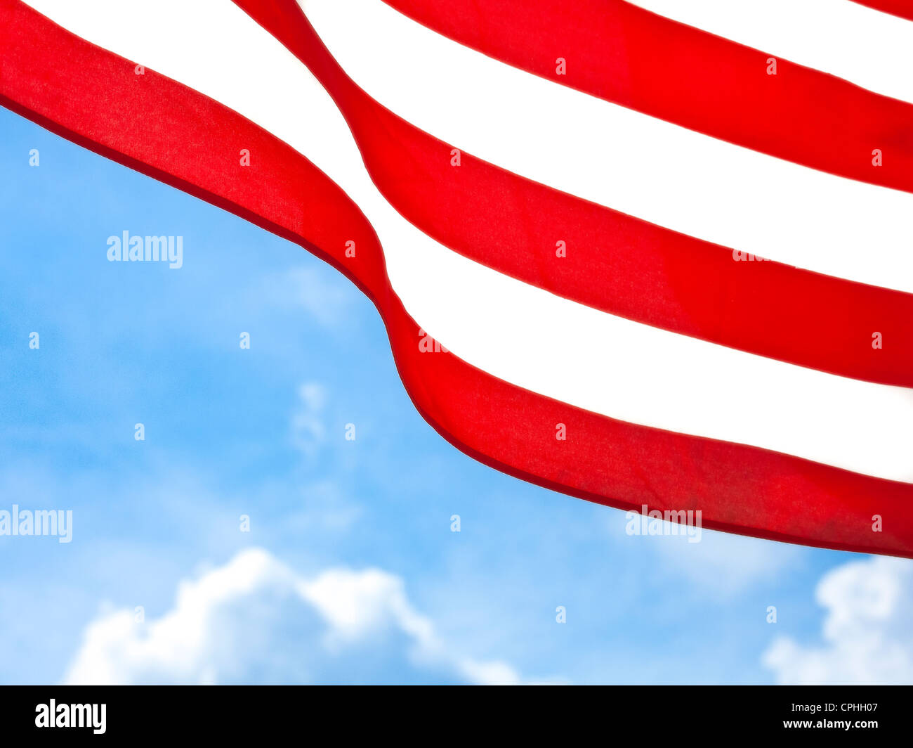 American flag rippling in the breeze. View is of lower striped edge ...
