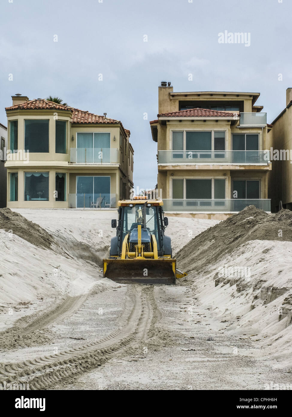 A Trench dug at the beach in Oxnard California with beach front homes ...