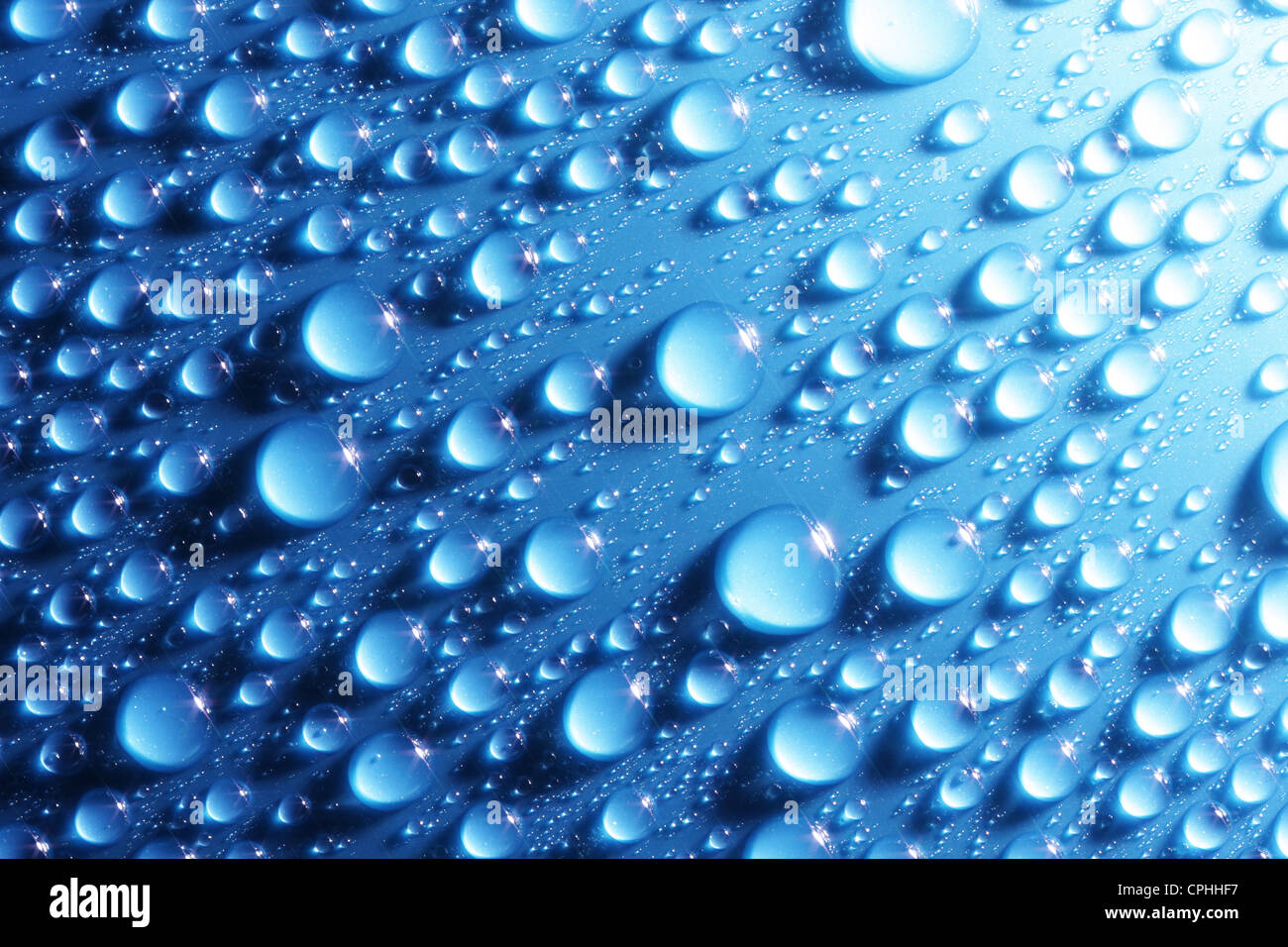 Shiny water drops on metallic blue surface Stock Photo - Alamy