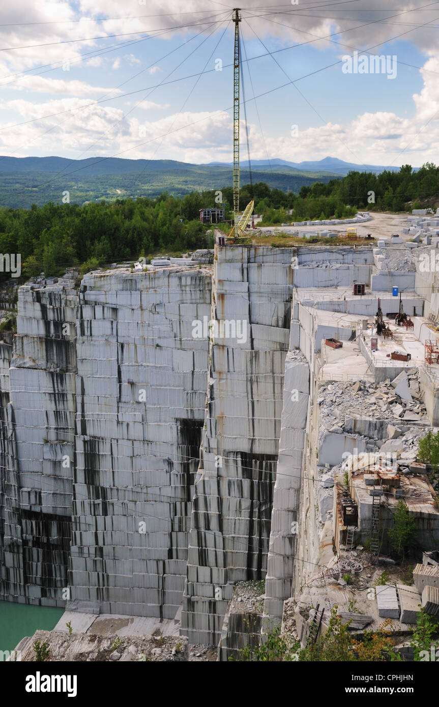 Tall cranes assist in excavation of granite at the Rock of Ages quarry ...