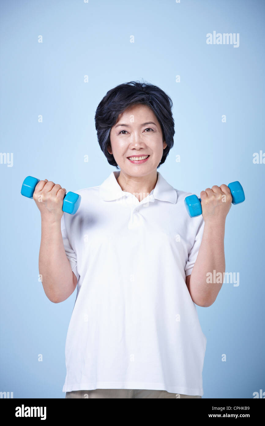An old woman exercising with dumbbell Stock Photo - Alamy