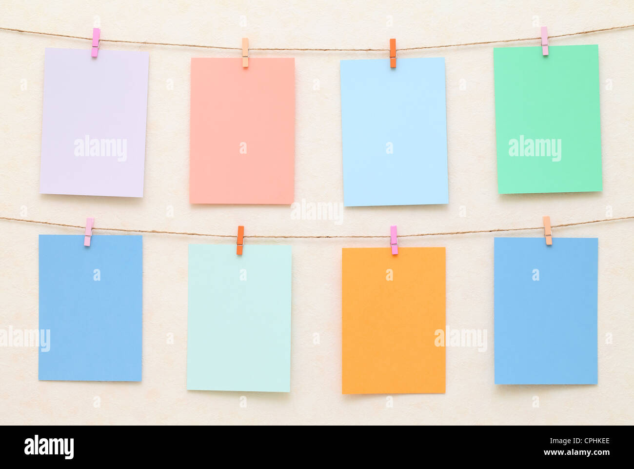 Hanging sheet of paper with clothespins Stock Photo - Alamy