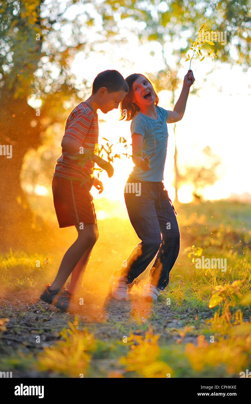 children playing on meadow Stock Photo - Alamy